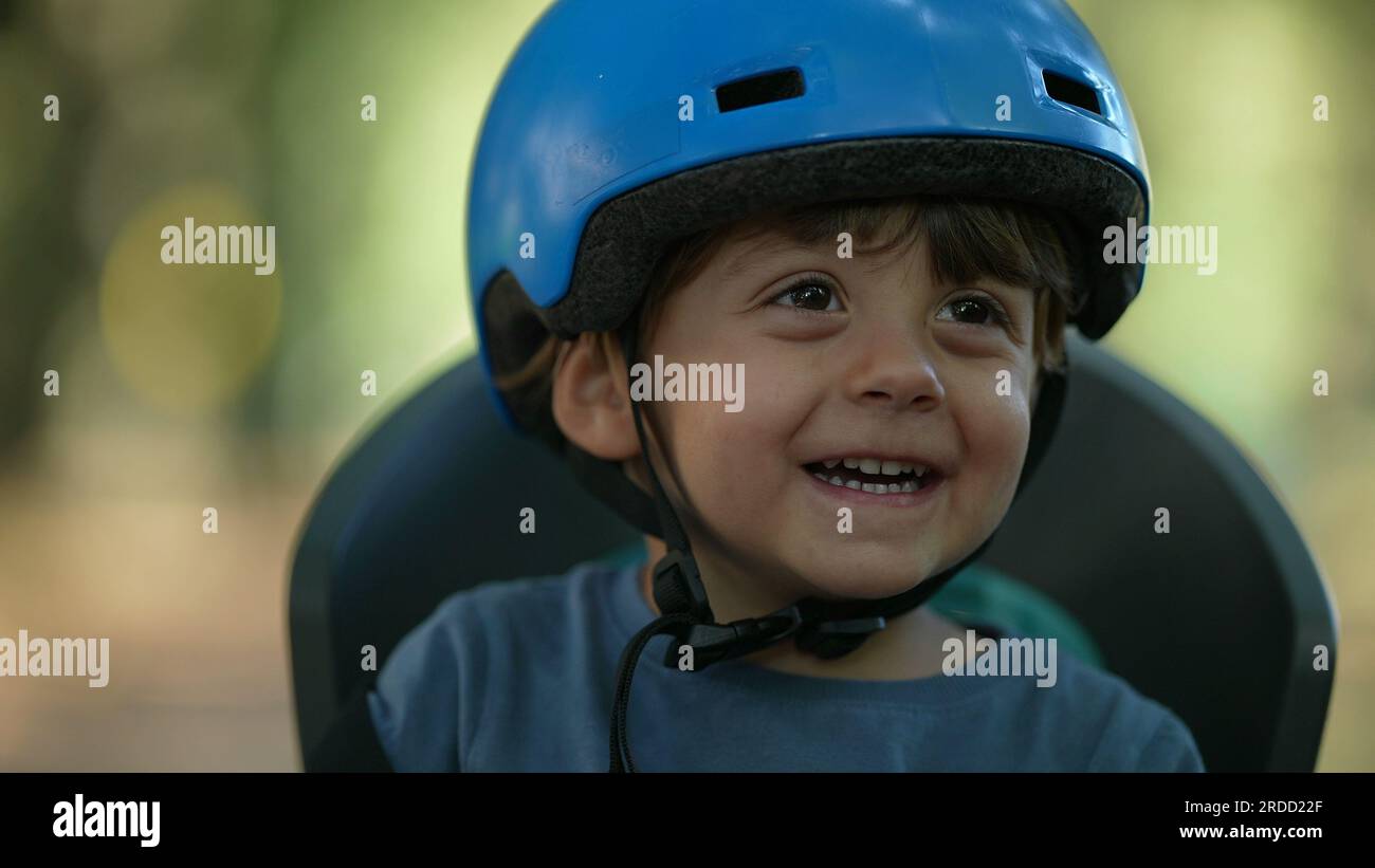 Child wearing bike helmet portrait kid sitting in bike back seat Stock ...