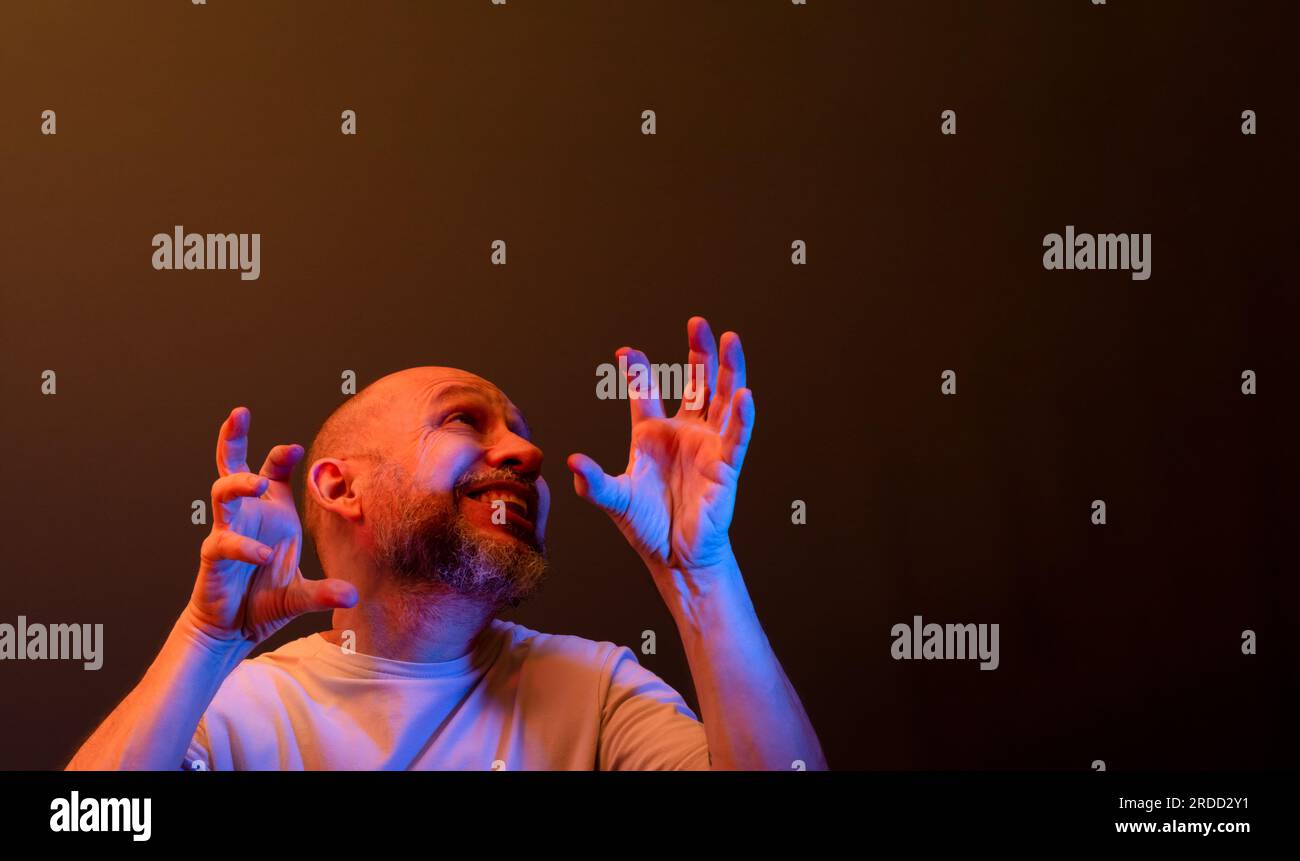Happy bald bearded man making funny hand gestures. Concept of strength ...