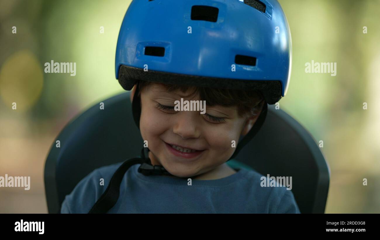 One happy little boy wearing bicycle helmet portrait face clapping ...