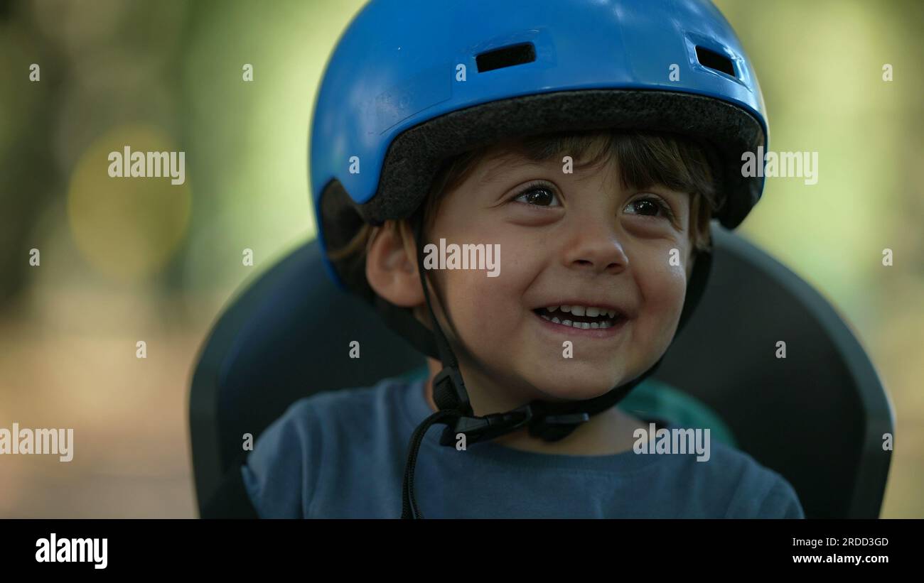 One happy little boy wearing bicycle helmet portrait face clapping ...