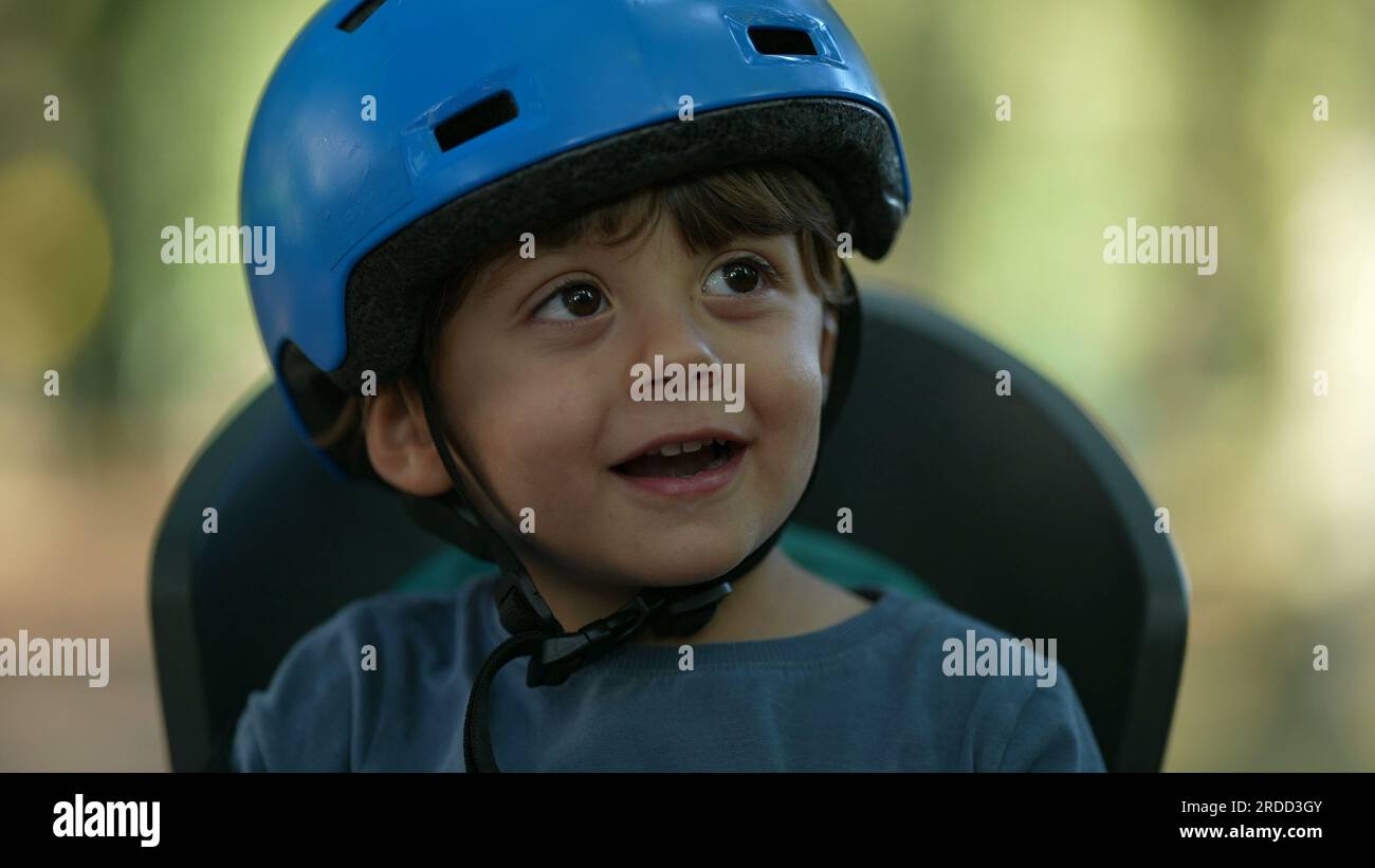 One happy little boy wearing bicycle helmet portrait face clapping ...