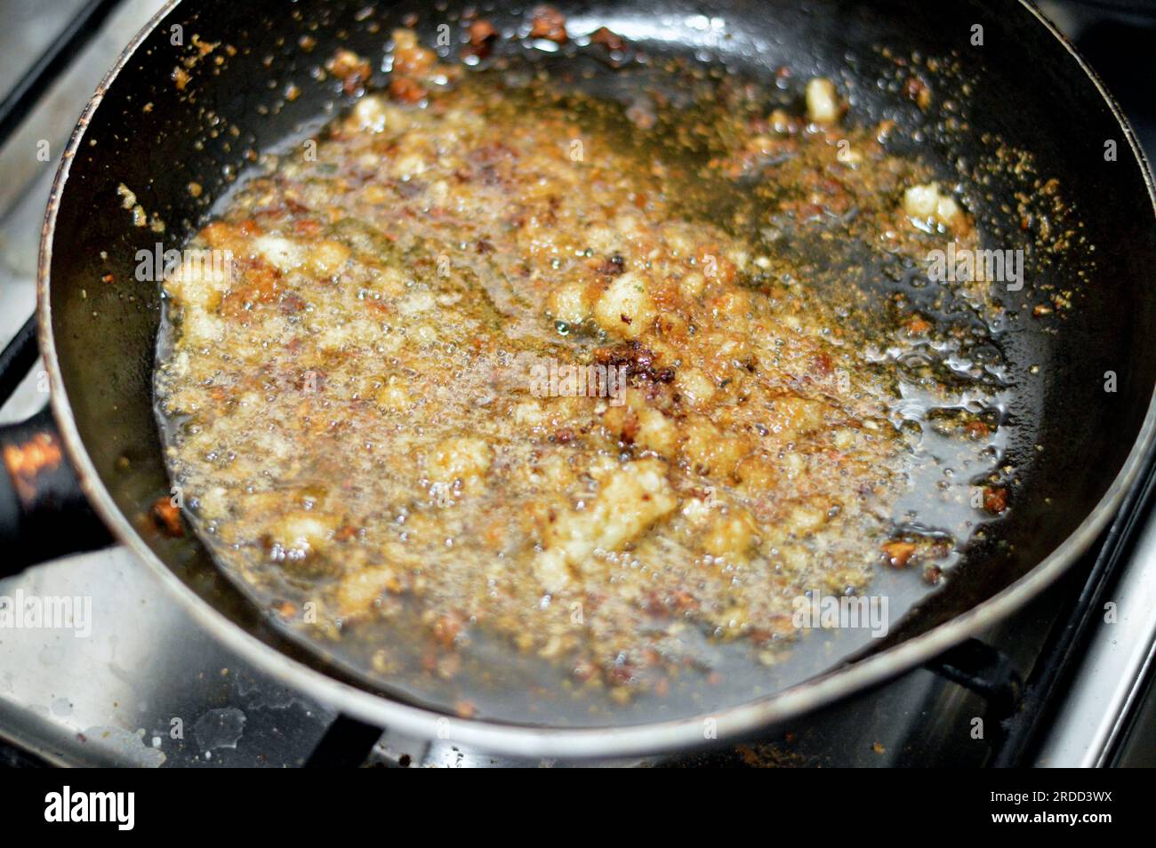preparing the last step of the popular Egyptian Molokhiya soup making ...