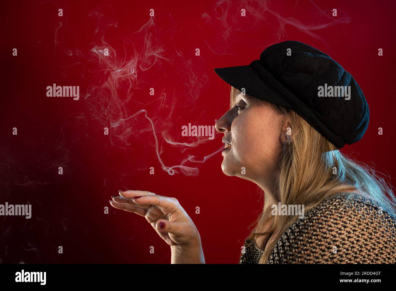 Studio portrait of attractive and beautiful woman with hand raised and ...