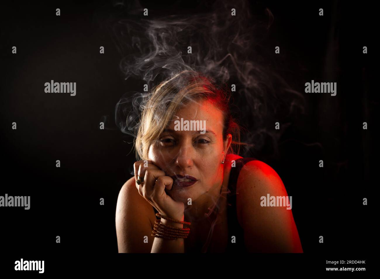 Attractive and beautiful calm woman looking at the camera with her ...