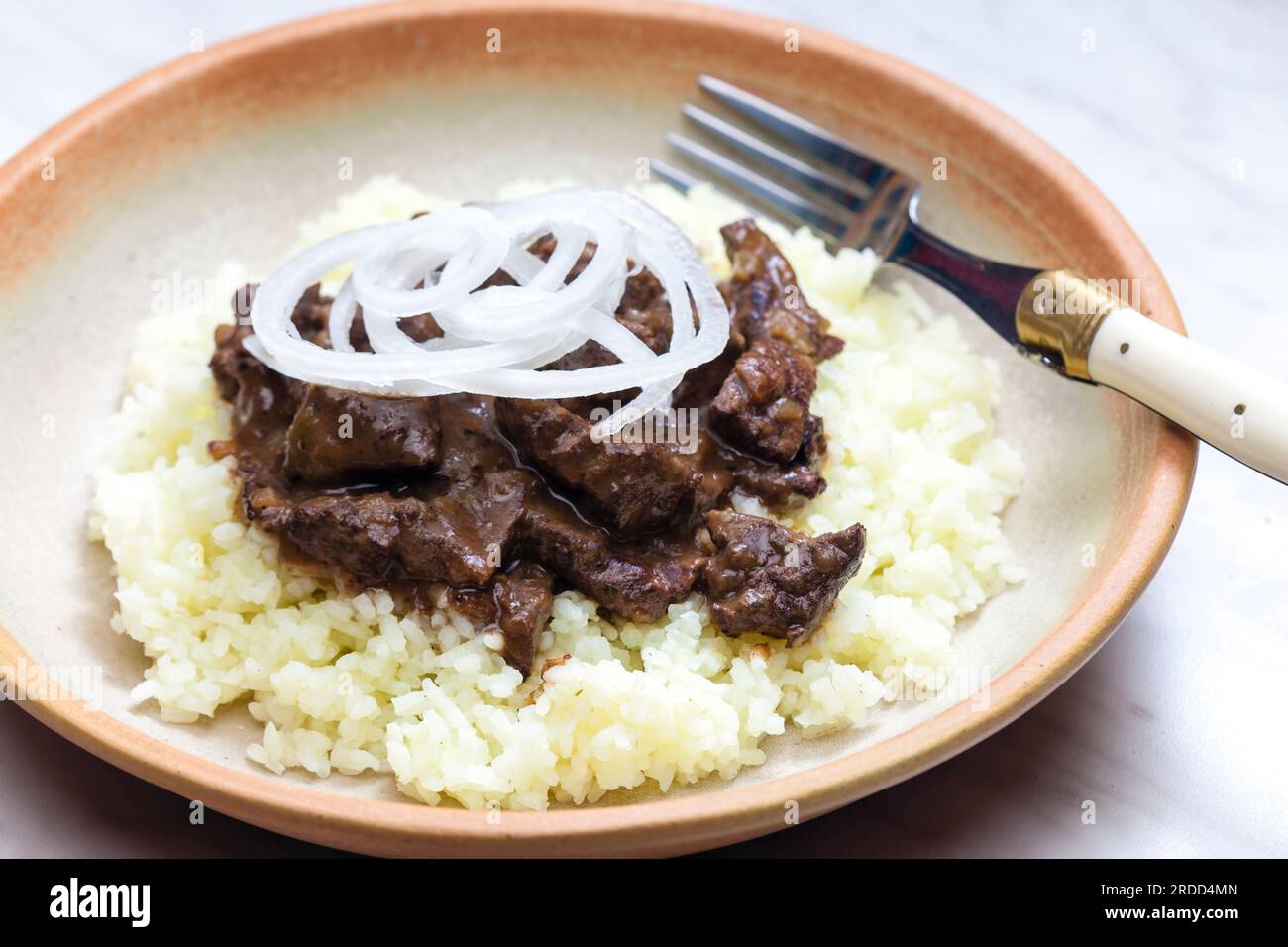 beef stew with rice and onion rings Stock Photo - Alamy