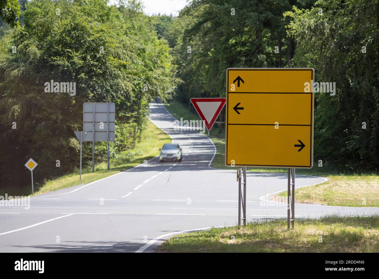 road junction with empty information signs and german traffic signs ...