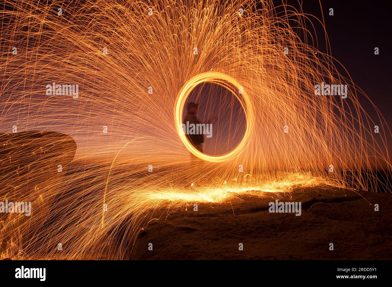 Person swinging fire ball golden yellow streaks hi-res stock ...