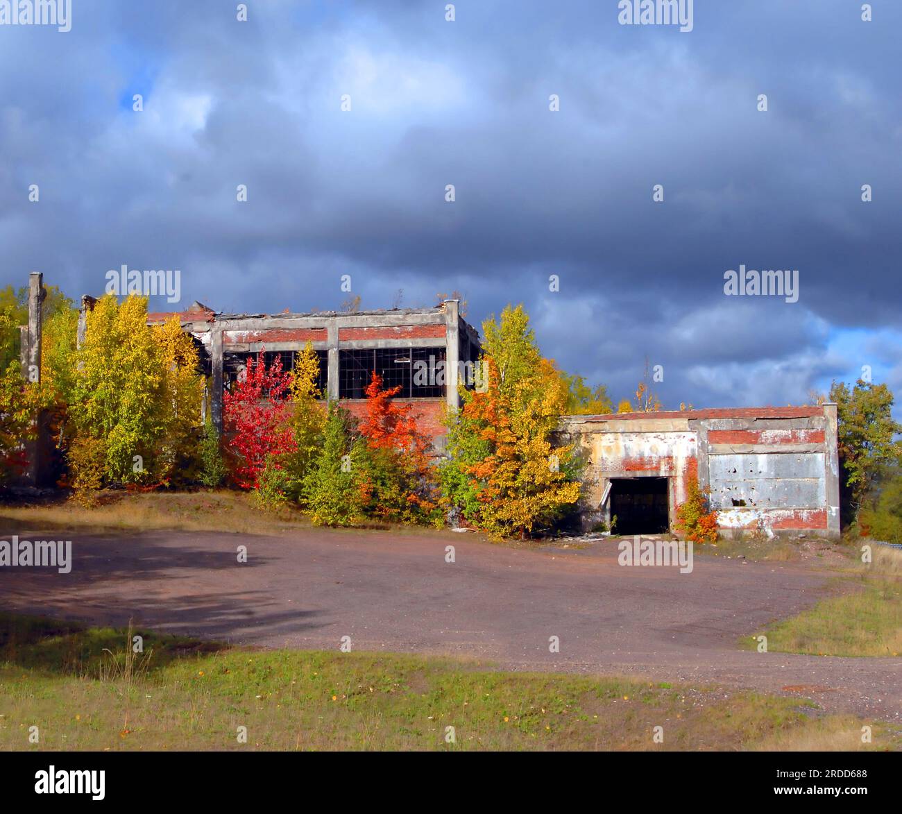 Fall trees and threatening sky frame abandoned Quincy Mining Company ...