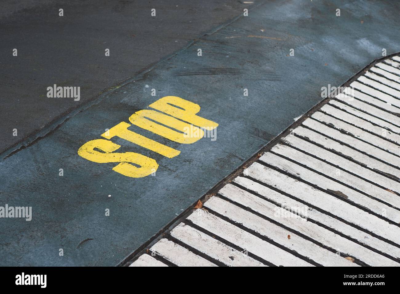 yellow color stop sign on road Stock Photo - Alamy