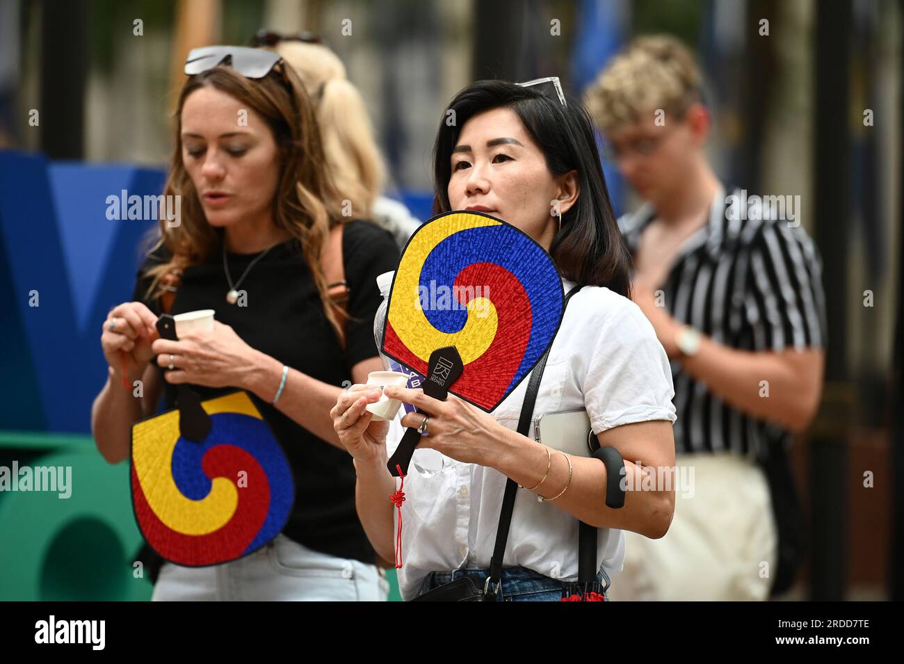 New York, USA. 19th July, 2023. Visitors hold Korean hand held fans ...