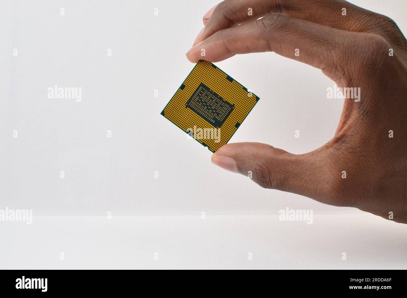Close-up of a hand holding a computer processor, symbolizing processing ...