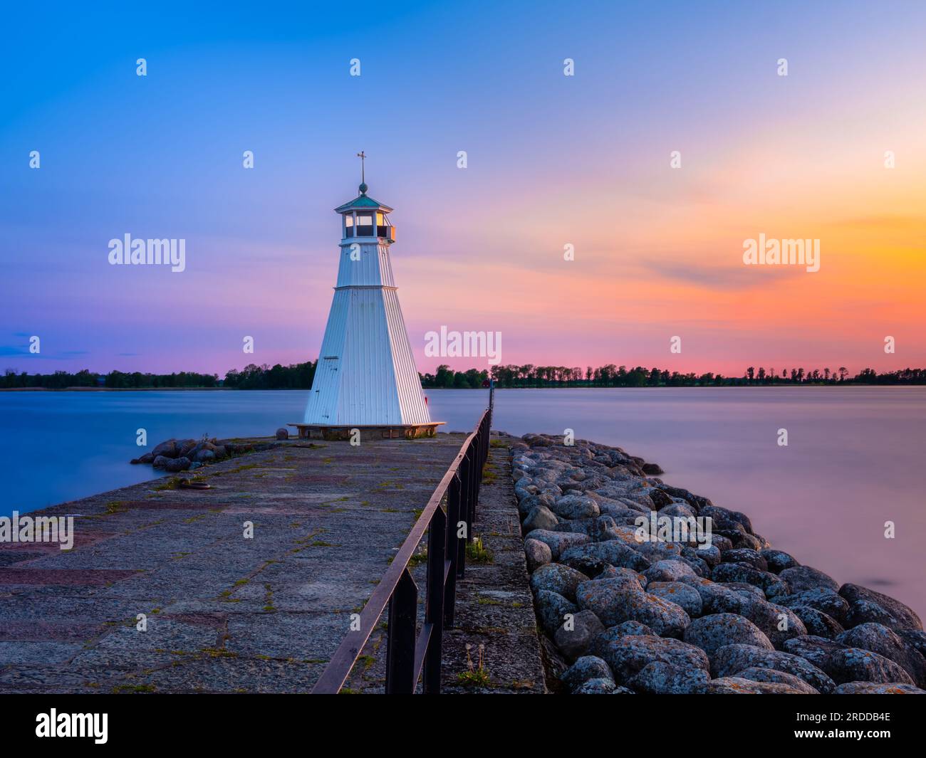 Historic lighthouse in a colorful sunset at Lake Vattern in Vadstena ...