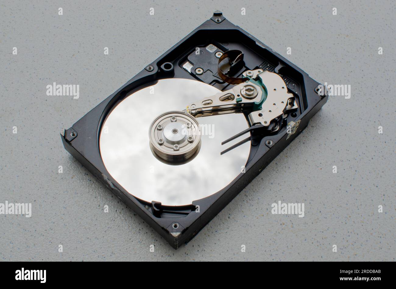Closeup of an open HDD revealing its gears and internal circuitry ...