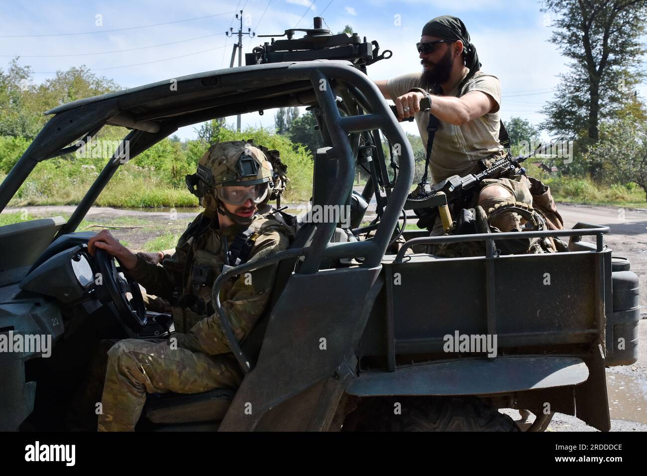 Ukrainian army soldiers drive towards the frontline on a combat buggy ...