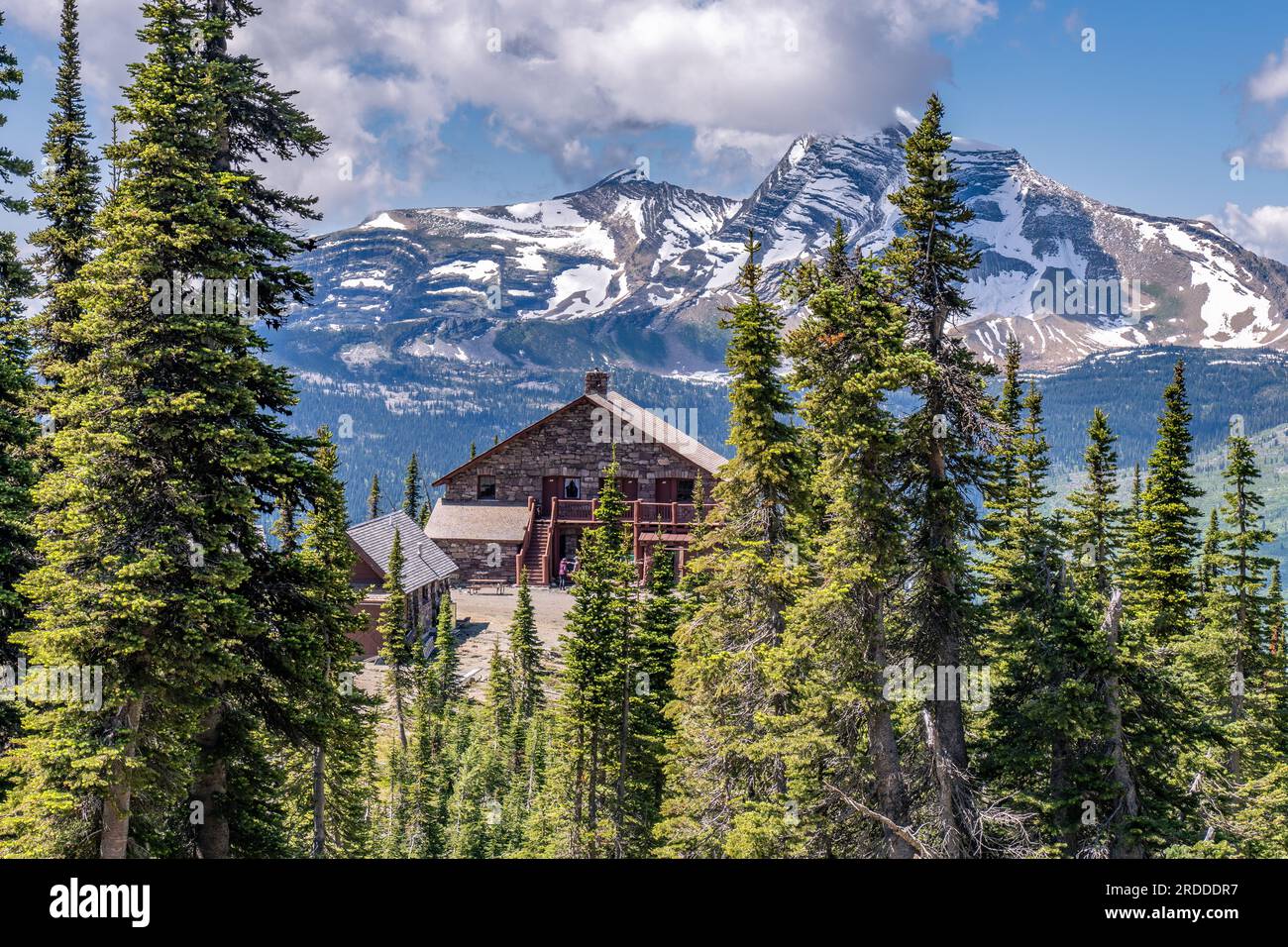 An historic stone structure nestle on a hill surrounded by mature pine trees and a rugged ...