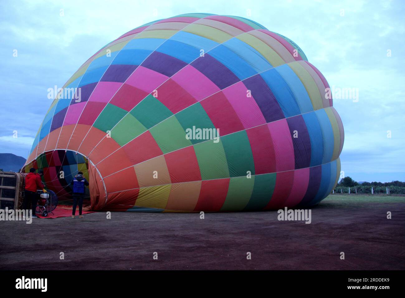 Process of inflation and preparation of hot air balloon at sunrise for ...