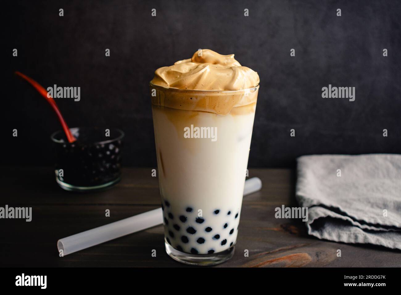 Iced Dalgona Coffee with Boba in a Pint Glass on a Dark Background ...