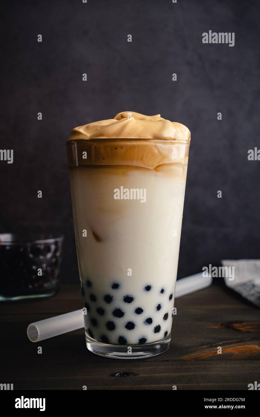 Iced Dalgona Coffee with Boba in a Pint Glass on a Dark Background ...