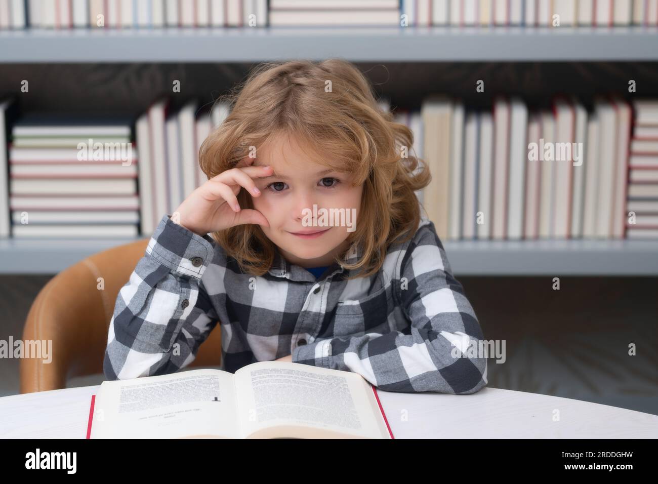 Boy choosing book from library hi-res stock photography and images - Alamy