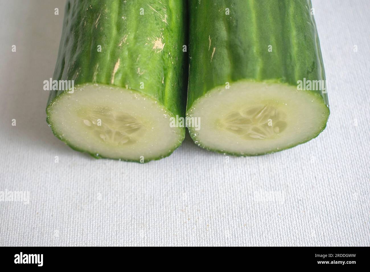 Fresh, raw green Persian cucumbers, grown organically. Presented on a ...