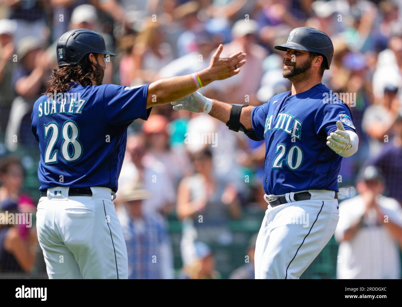 Seattle Mariners' Eugenio Suarez (28) greets Mike Ford (20) after ...