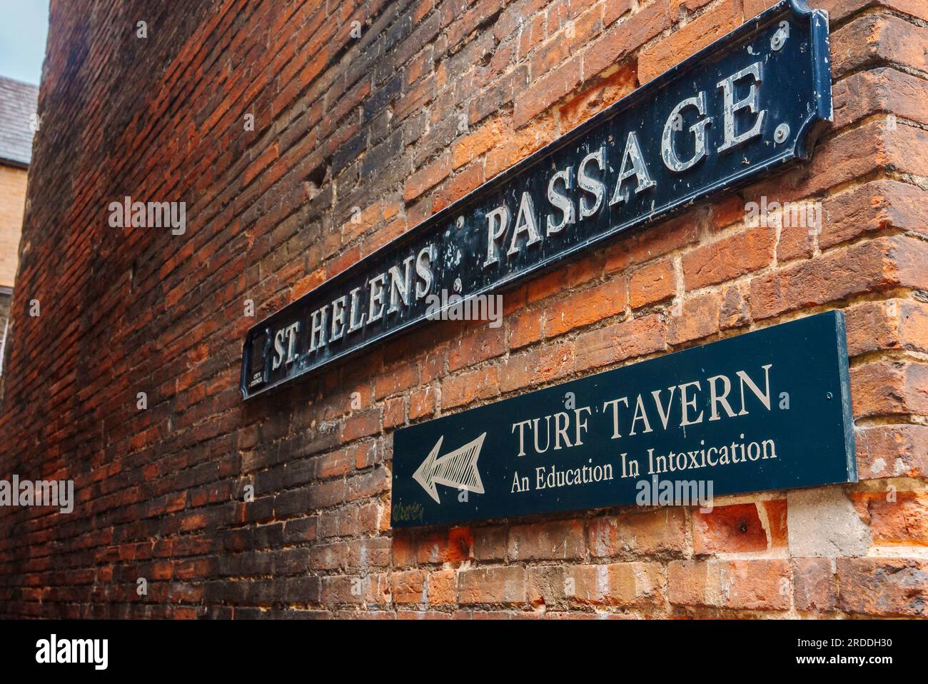 St. Helen's Passage, Turf Tavern directional sign on brick wall Stock ...