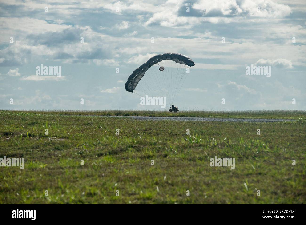 A U.S. Army Soldier captures a parachute after free-fall jumping into ...