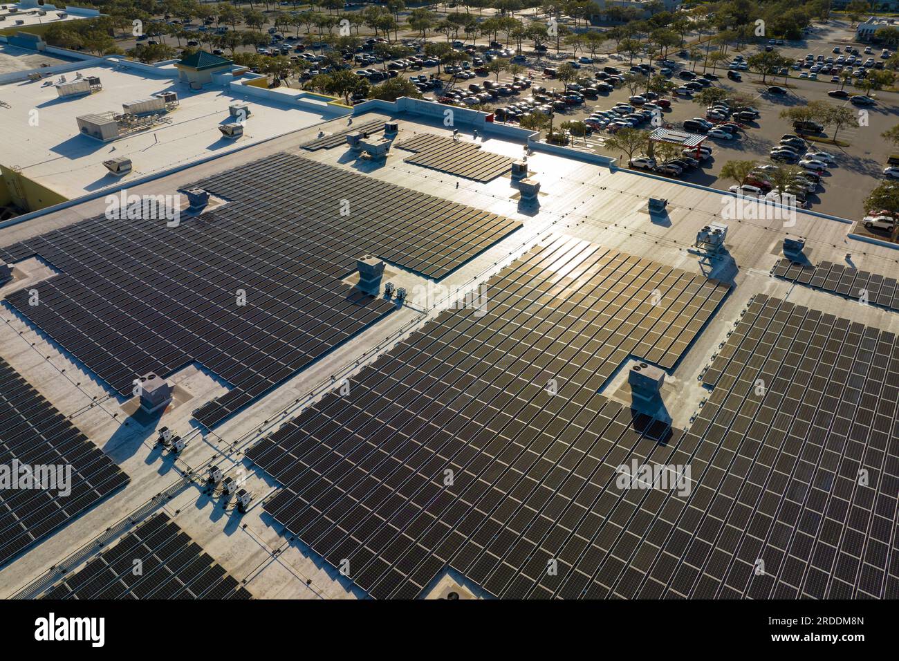 Aerial view of blue photovoltaic solar panels mounted on shopping mall ...