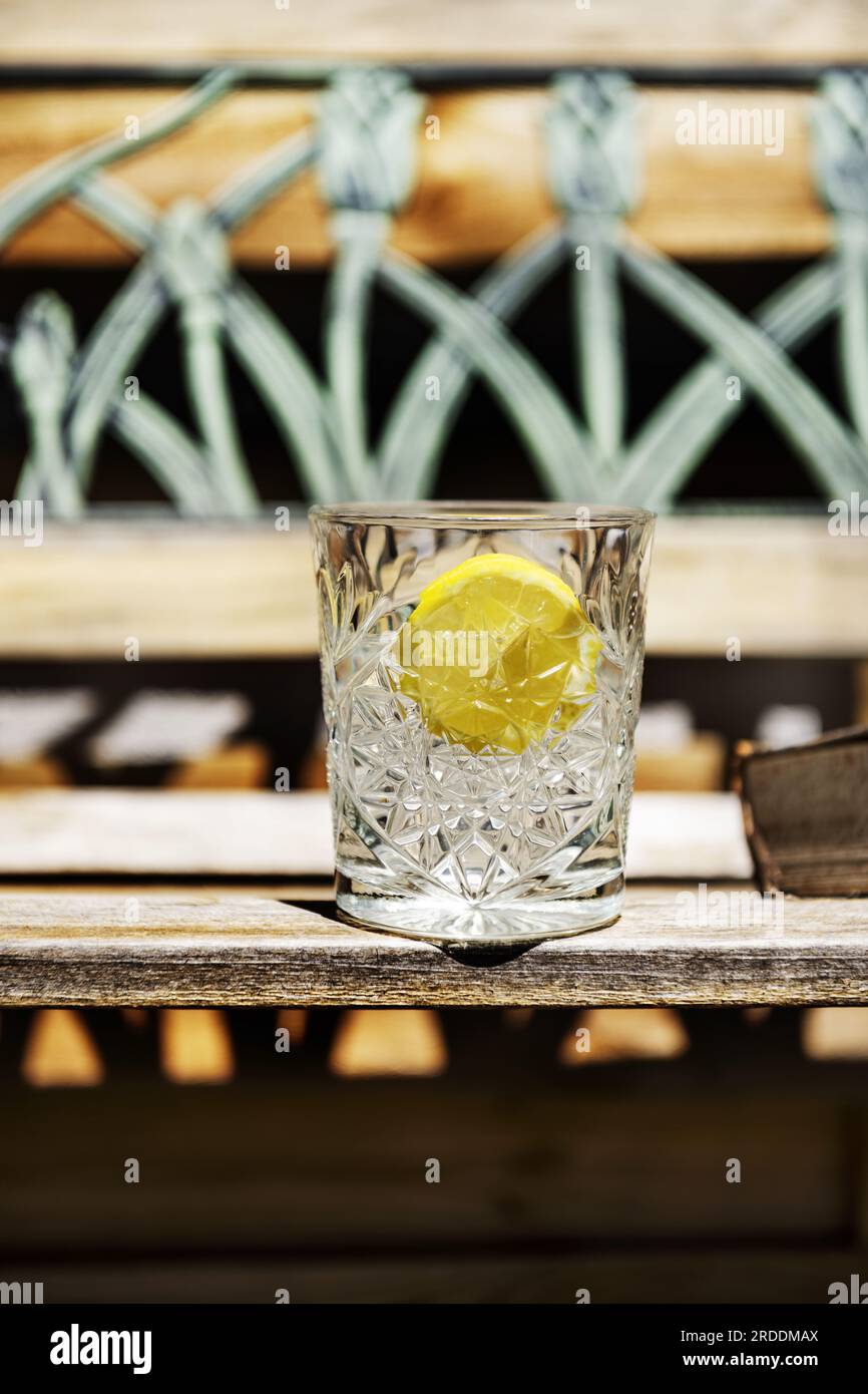 A cut crystal glass with cold water and a slice of lemon for drinks ...