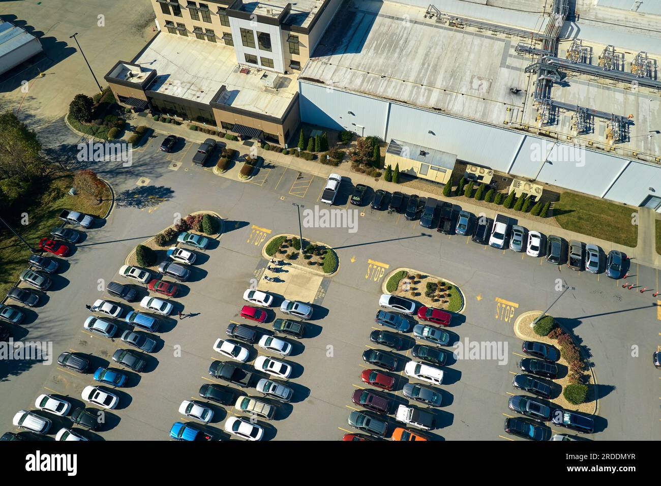 Aerial view of many employee cars parked on parking lot in front of ...