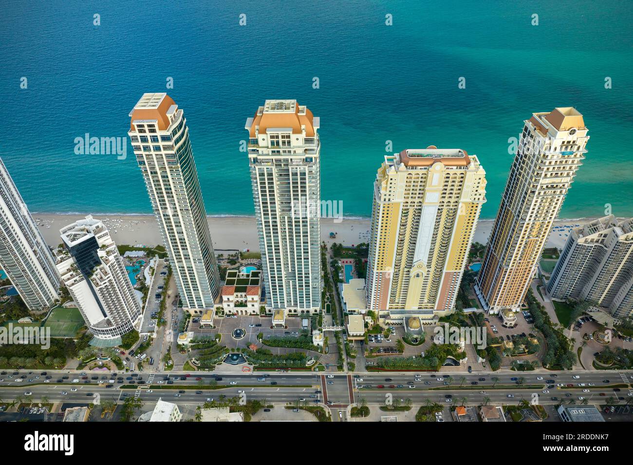Aerial view of Sunny Isles Beach city with congested street traffic and ...