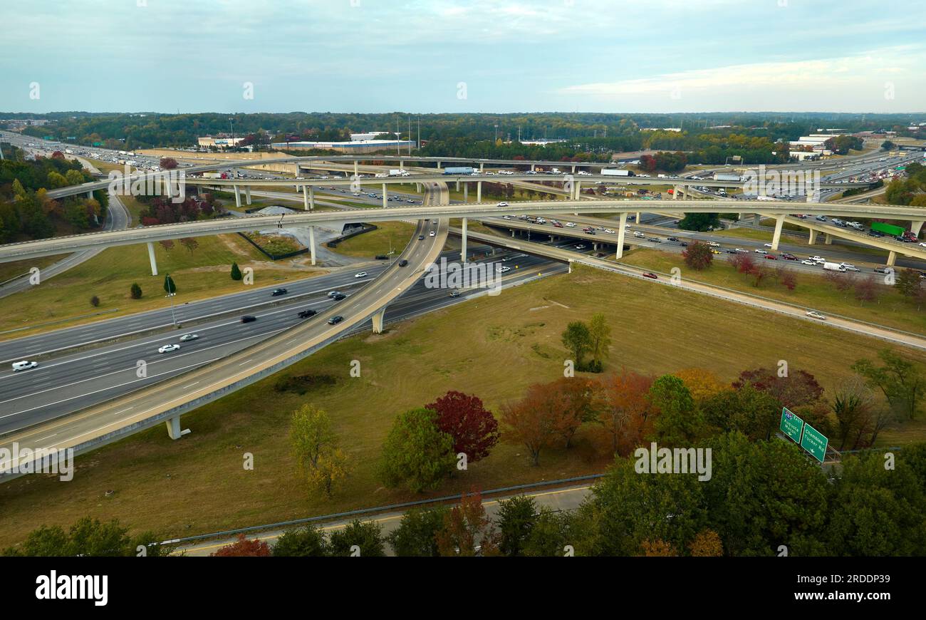 American freeway intersection with fast driving cars and trucks. View ...