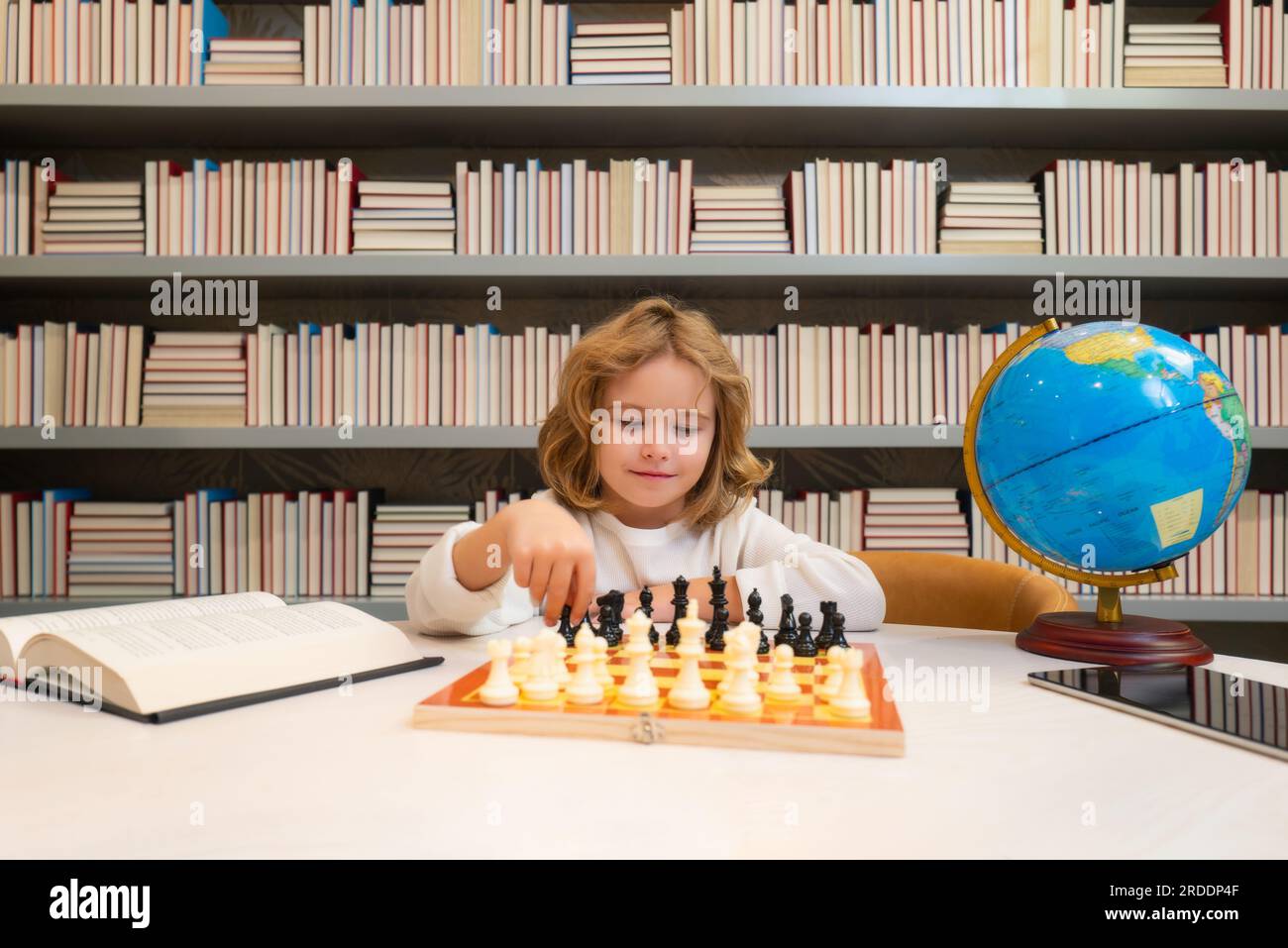 Child boy developing chess strategy, playing board game. Schoolboy ...