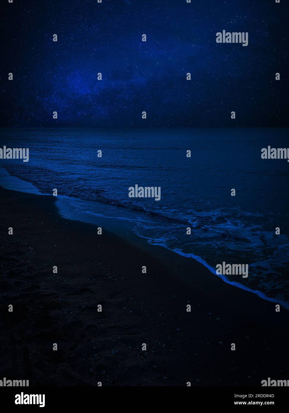 Sea waves rolling onto sandy beach under starry sky at night Stock ...