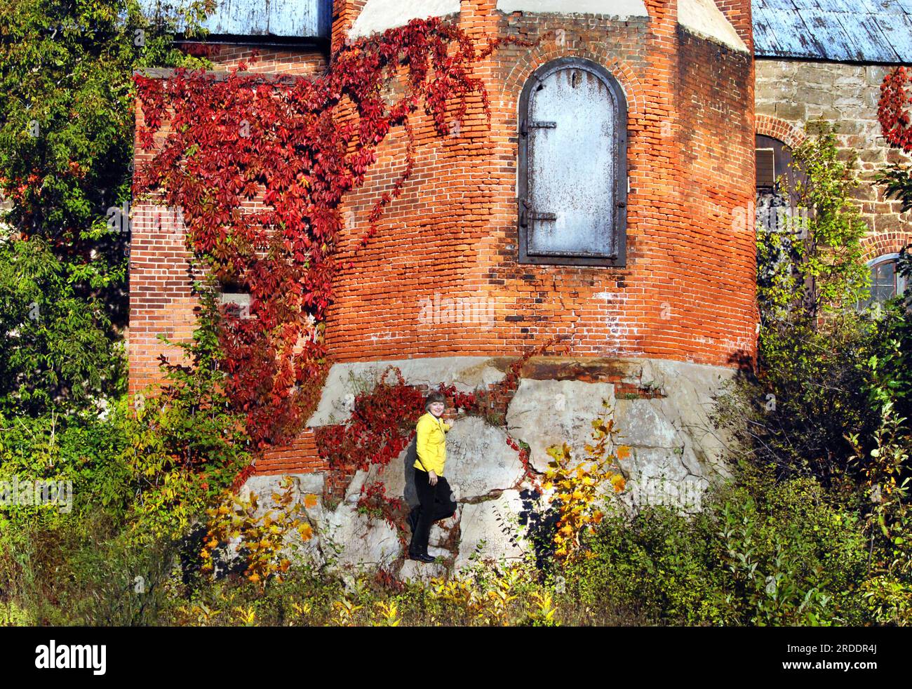 Female visitor explores Smokestack base of the Calumet and Hecla County ...