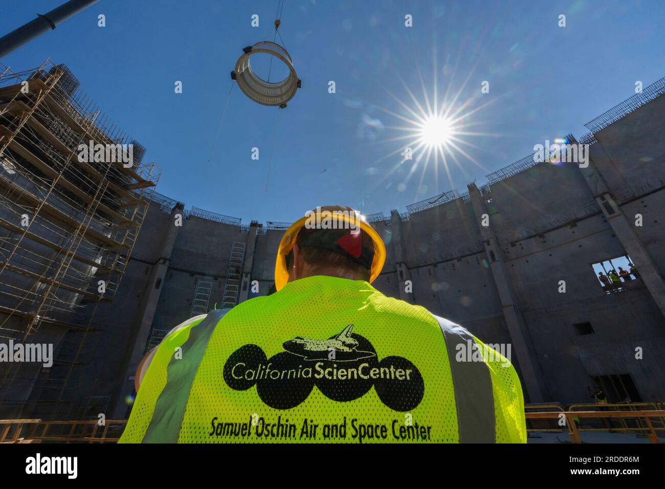 Workers use a crane to hoist one of the two Space Shuttle Endeavour's ...