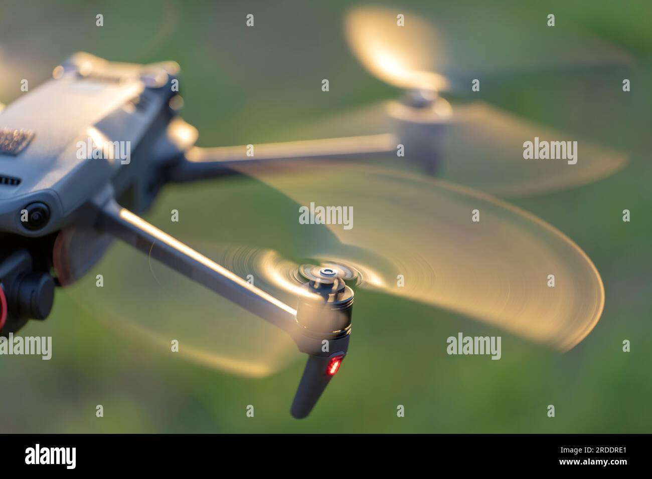 Drone aircraft with blurred fast rotating propellers and video camera ...