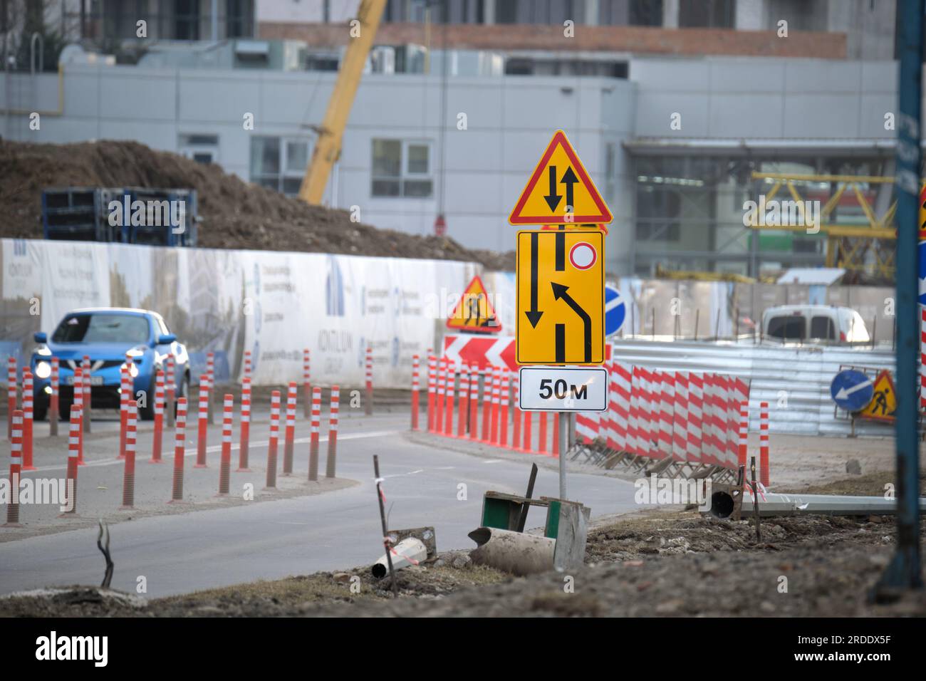 Roadworks warning traffic signs of construction work on city street and ...