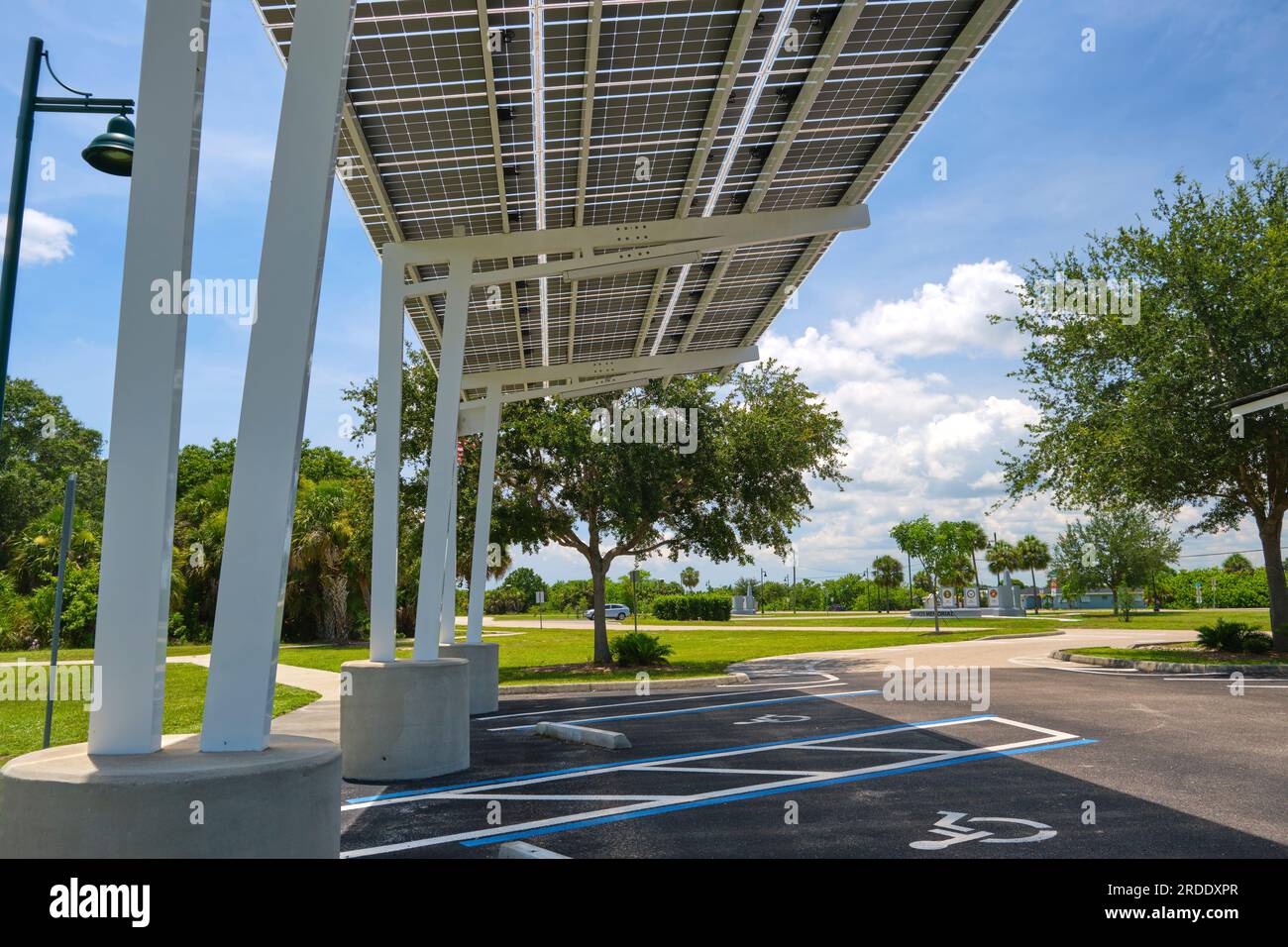 Solar panels installed as shade roof over parking lot for parked ...