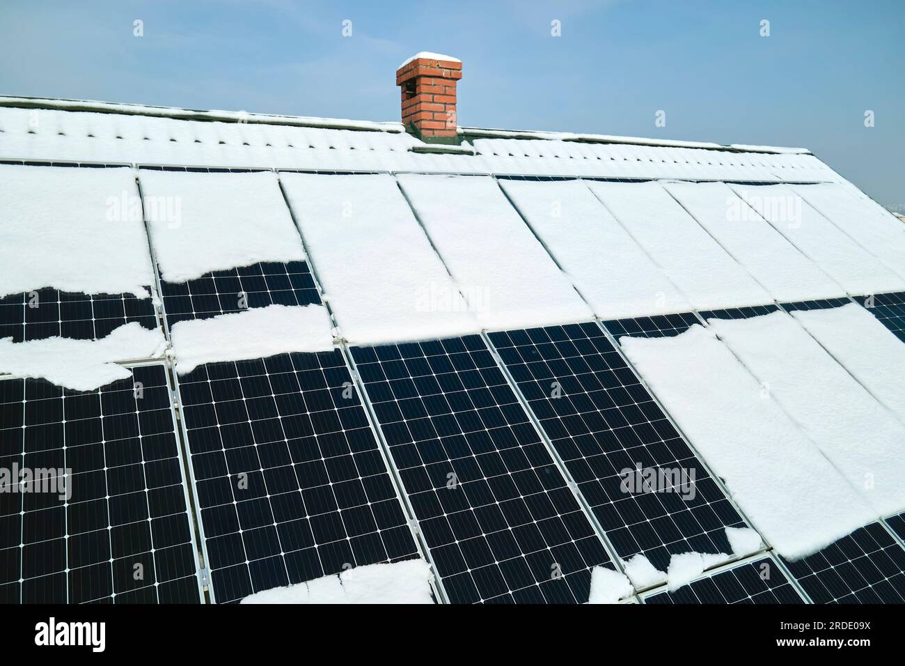 Aerial view of snow melting from covered solar photovoltaic panels ...