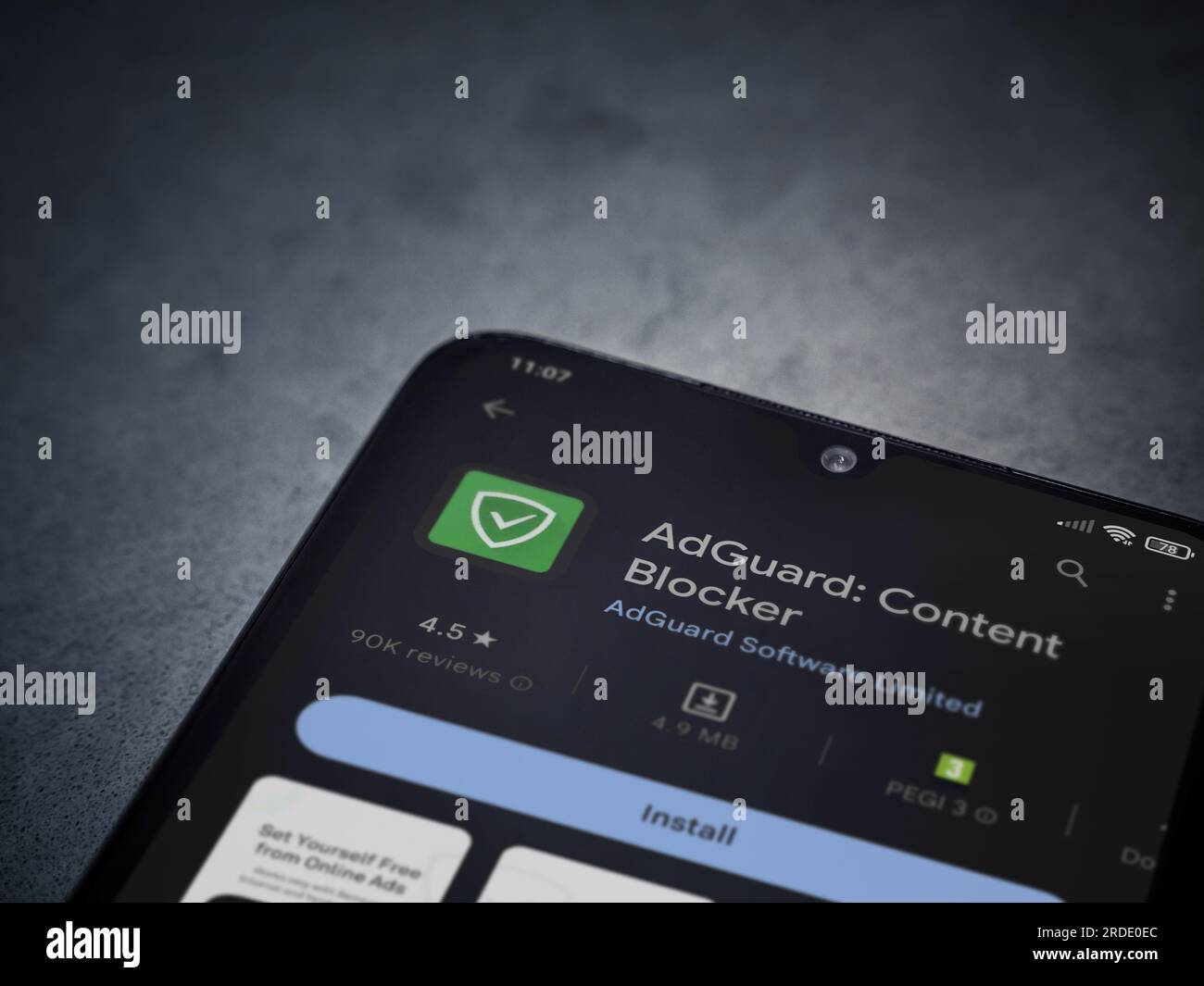 Lod, Israel - July 16,2023: AdGuard app play store page on smartphone on a dark marble stone ...