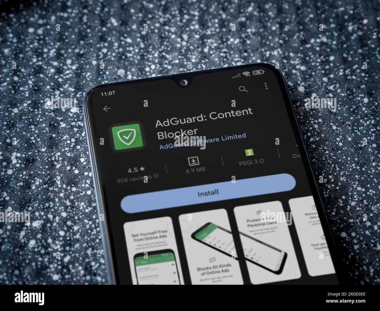 Lod, Israel - July 16,2023: AdGuard app play store page on smartphone on a metallic background ...
