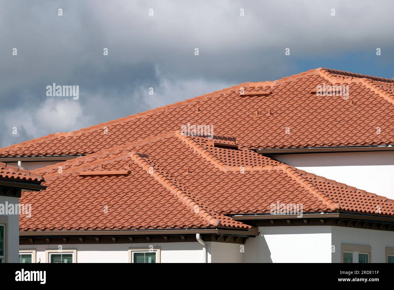 House rooftop covered with yellow ceramic shingles. Tiled covering of ...