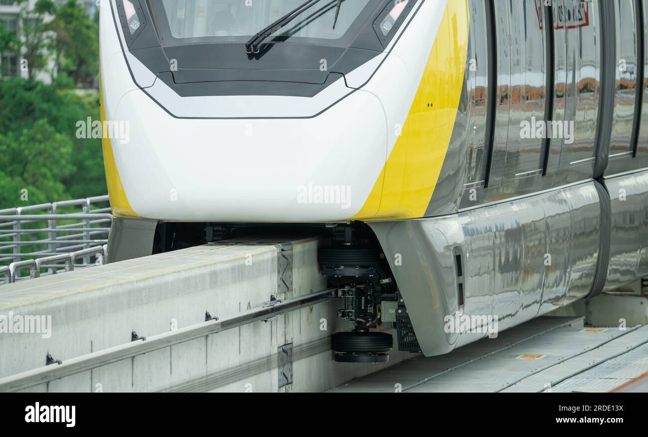 Elevated monorail train on rail. Guide wheels rubber tire on concrete ...
