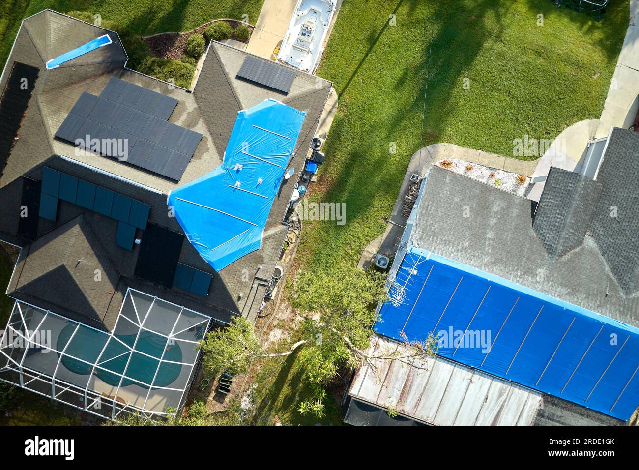 Top view of leaking house roofs covered with protective tarp sheets ...