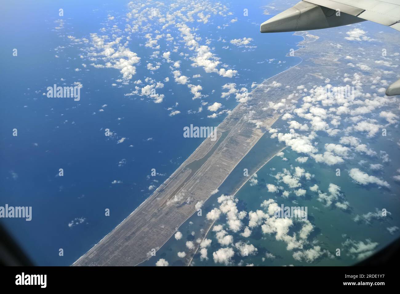 View through airplane window of commercial jet plane wing flying high ...