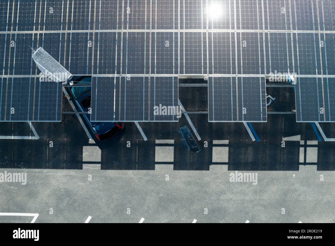 Wind damage to solar panels installed over parking lot canopy shade for ...