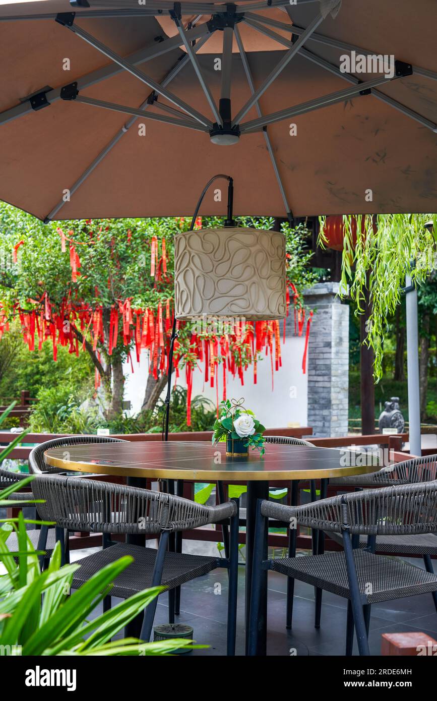 Luxurious Chinese garden restaurant seats and ancient building turret ...