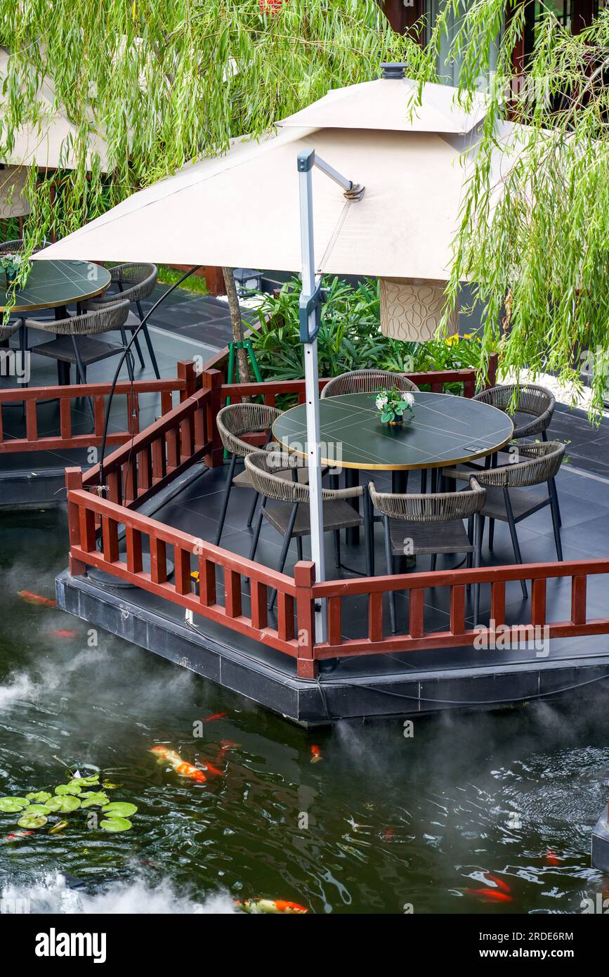 Luxurious Chinese garden restaurant seats and ancient building turret ...