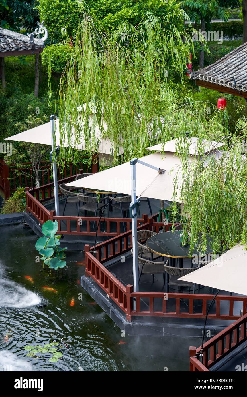 Luxurious Chinese garden restaurant seats and ancient building turret ...